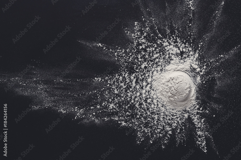 Sprinkled wheat flour splash spots on black background Stock Photo ...