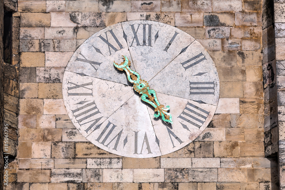 Clock on the Lisbon Cathedral's tower. The cathedral was originated in ...