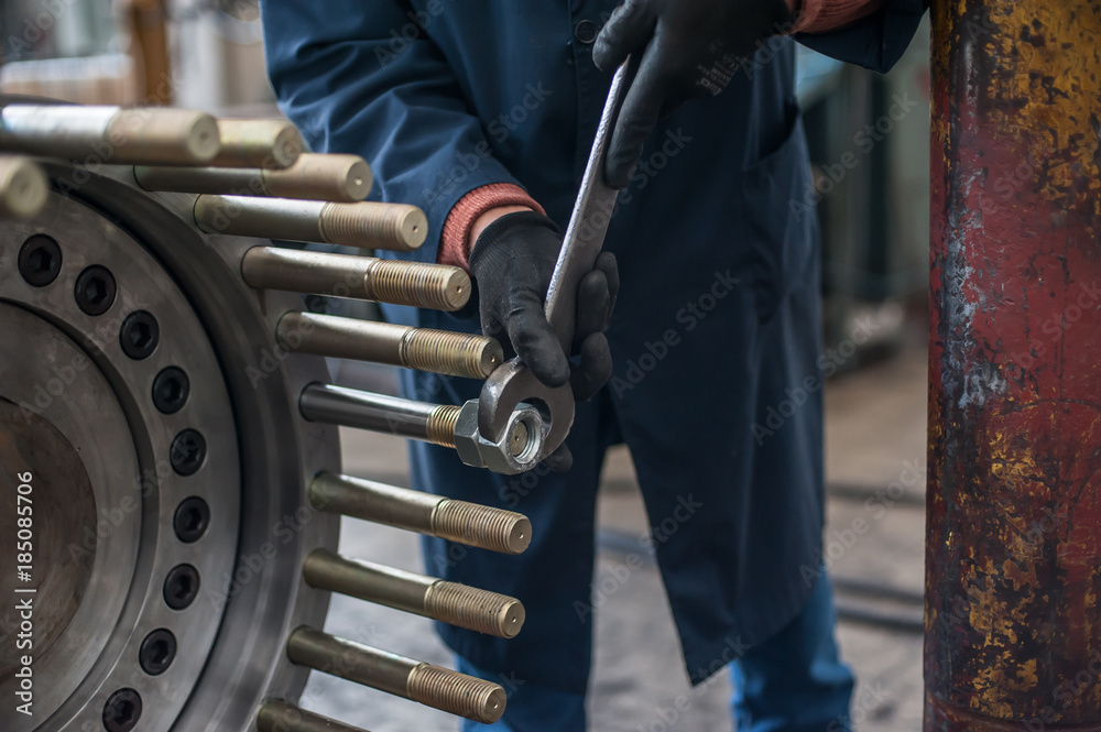 Mechanic screws big bolt with large and heavy wrench key Stock Photo ...