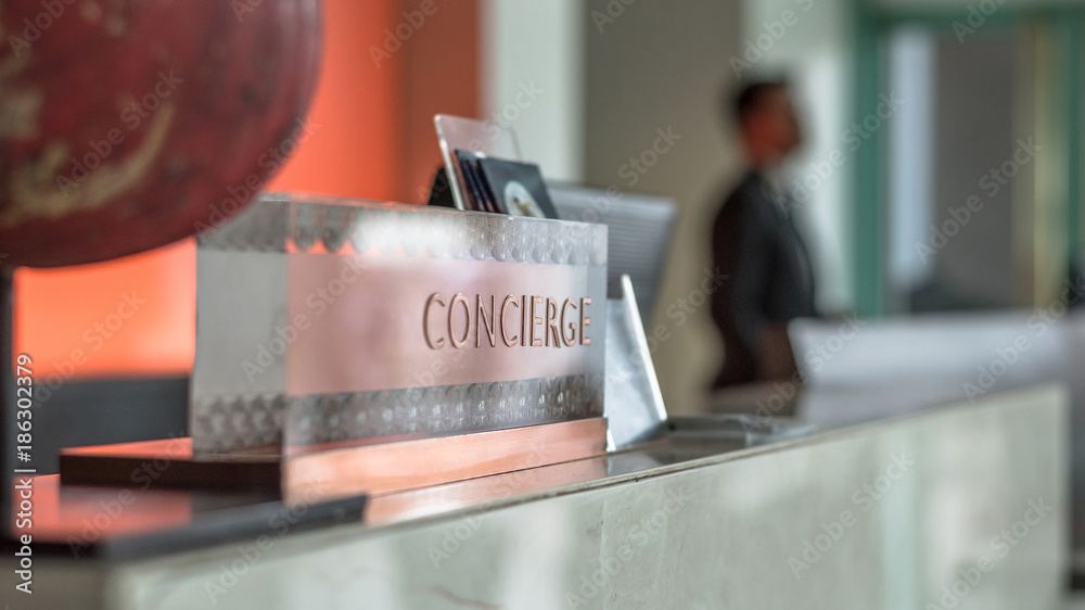 Concierge service desk counter with hotel staff team working in front ...