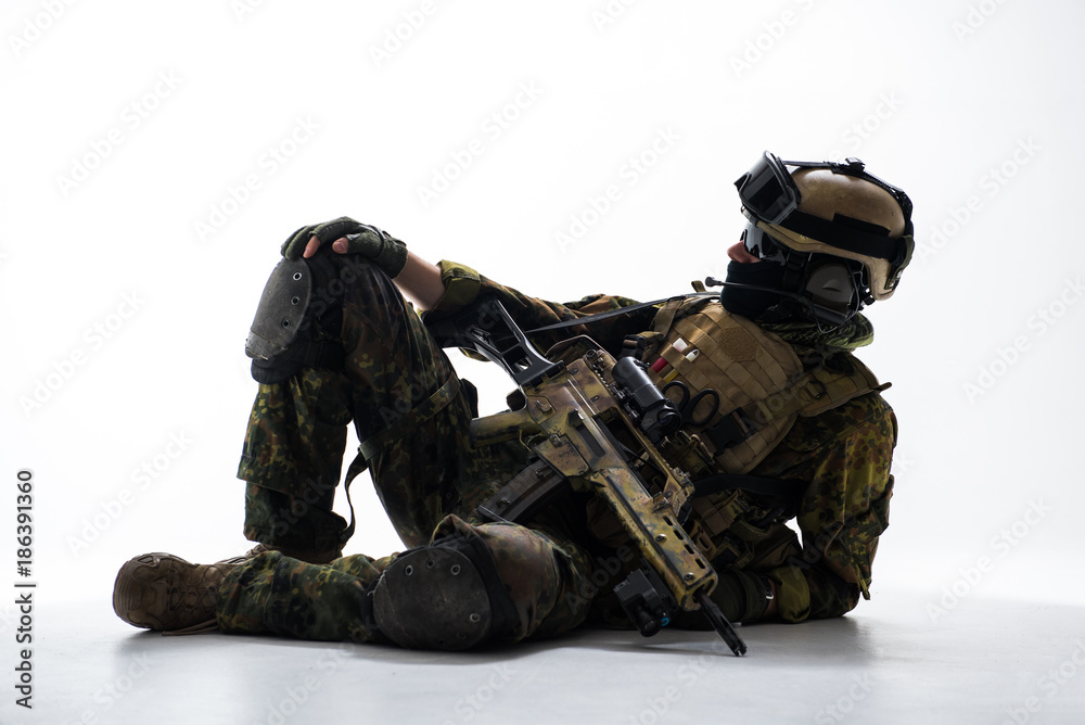 Full length side view calm soldier having rest. He keeping assault ...