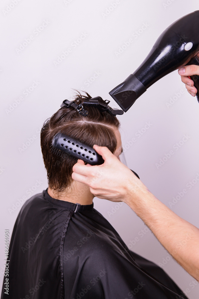 The process of male haircuts. A hairdresser is cutting a guy. Barber ...