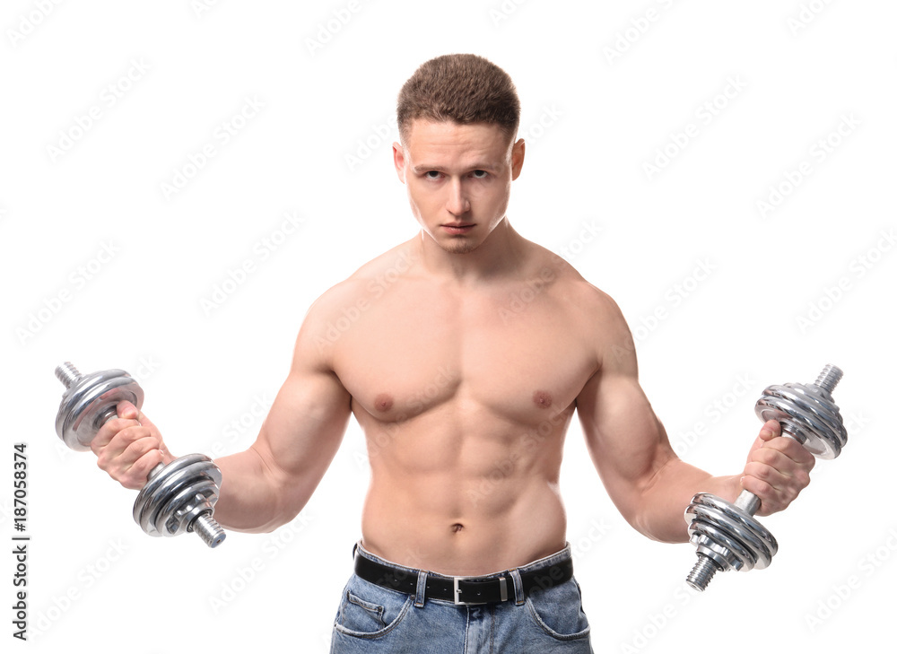 Muscular young bodybuilder with dumbbells on white background の Stock ...