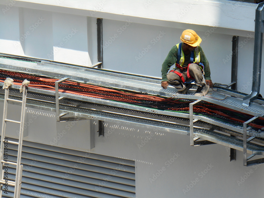 Electrical contractor installing electrical cable tray at the ...