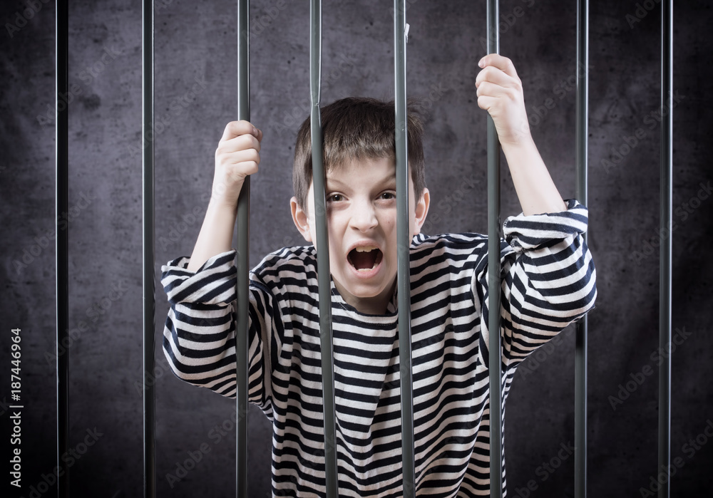 Boy in prison Stock Photo | Adobe Stock