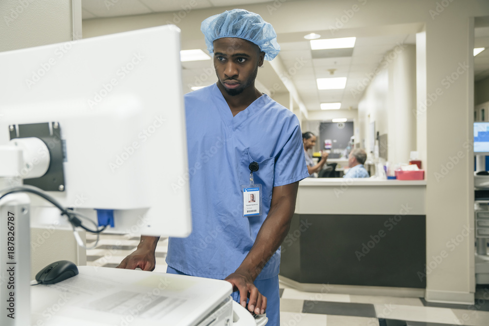 Male nurse using computer in a hospital Stock Photo | Adobe Stock