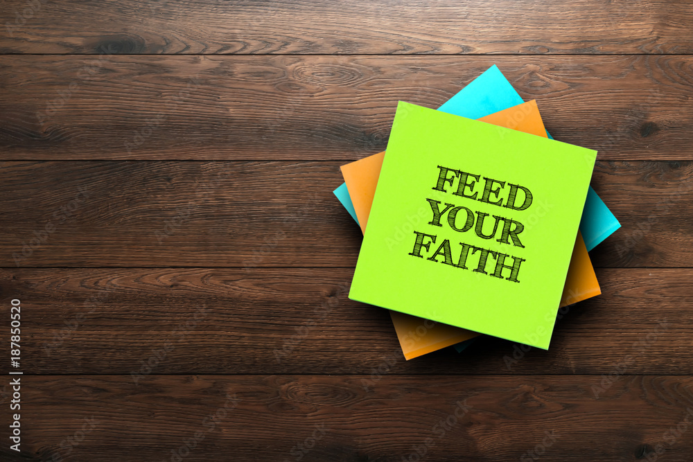 Feed Your Faith, the phrase is written on multi-colored stickers, on a ...