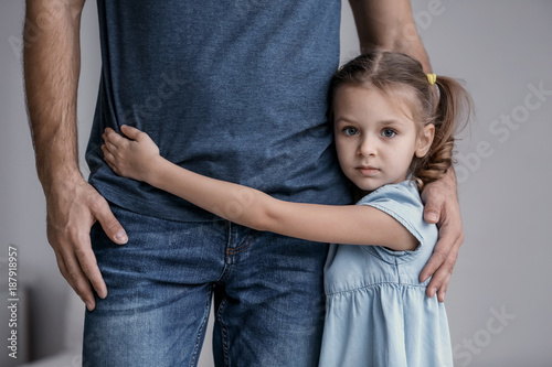 Sad little girl hugging her father indoors Stock Photo | Adobe Stock