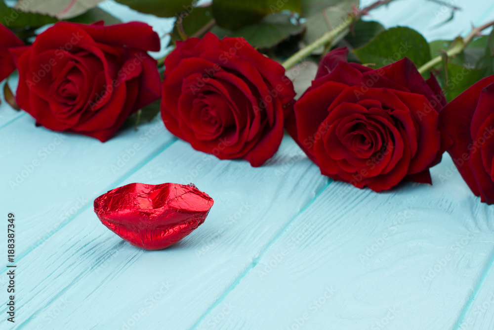 Red roses and red candy lips. Close up red beautiful rose for ...