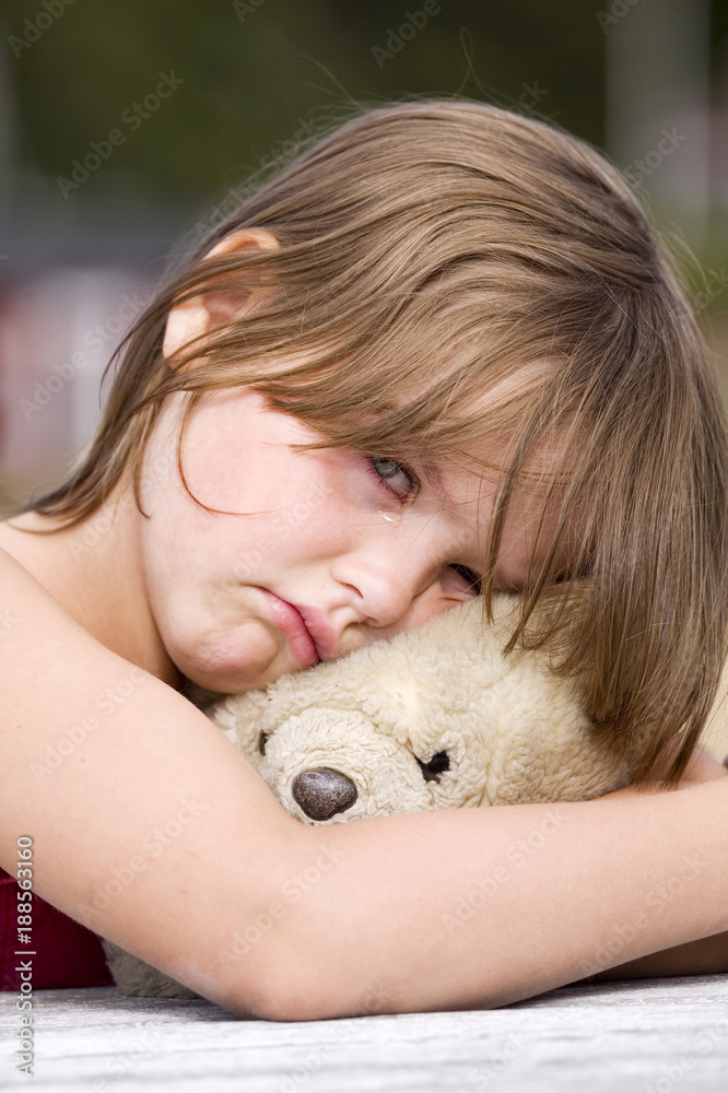 Little girl hugging teddy bear Stock Photo | Adobe Stock