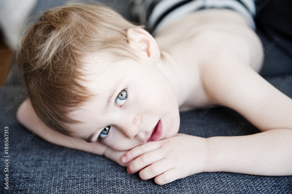 Shirtless boy lying on blanket Stock Photo | Adobe Stock