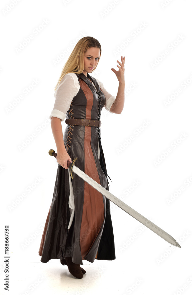 full length portrait of girl wearing brown fantasy costume, holding a ...