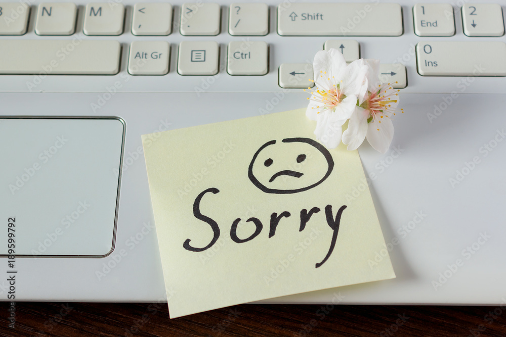 Handwritten note is on the keyboard. - I'm Sorry. Small delicate white ...
