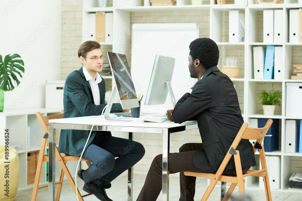 Full length portrait of two male office workers, one of them African ...