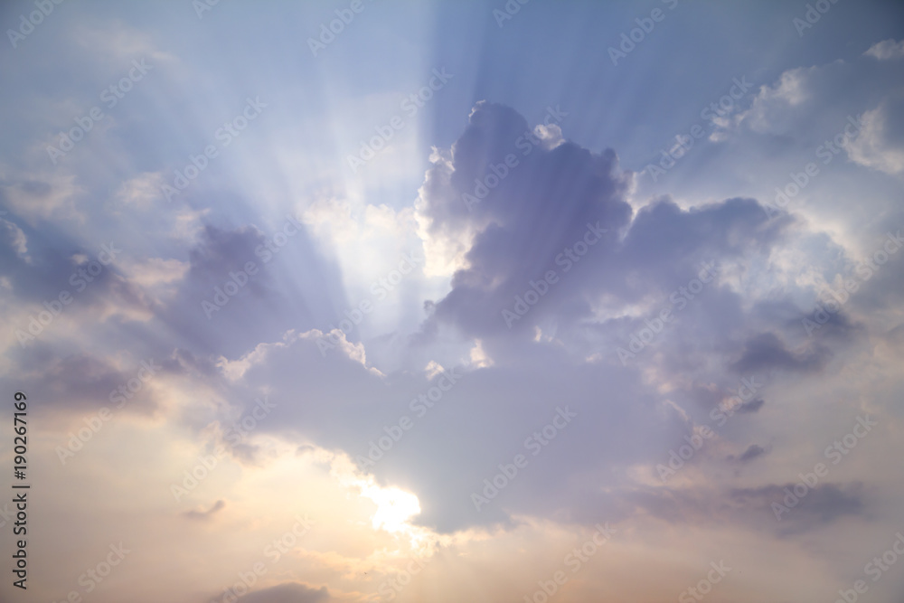 Sun shines through white clouds caused rays of light on hazy day blue ...
