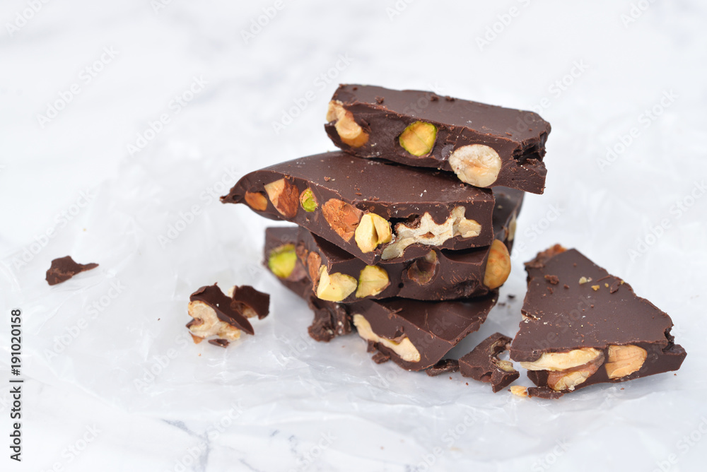 Dark chocolate bark with mixed nuts on wax paper Stock Photo | Adobe Stock