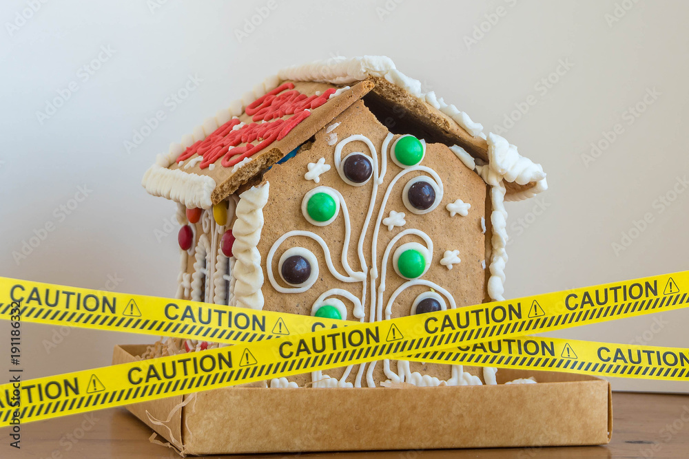 Ruined gingerbread house behind a police tape. Ruined walls, mortgage ...