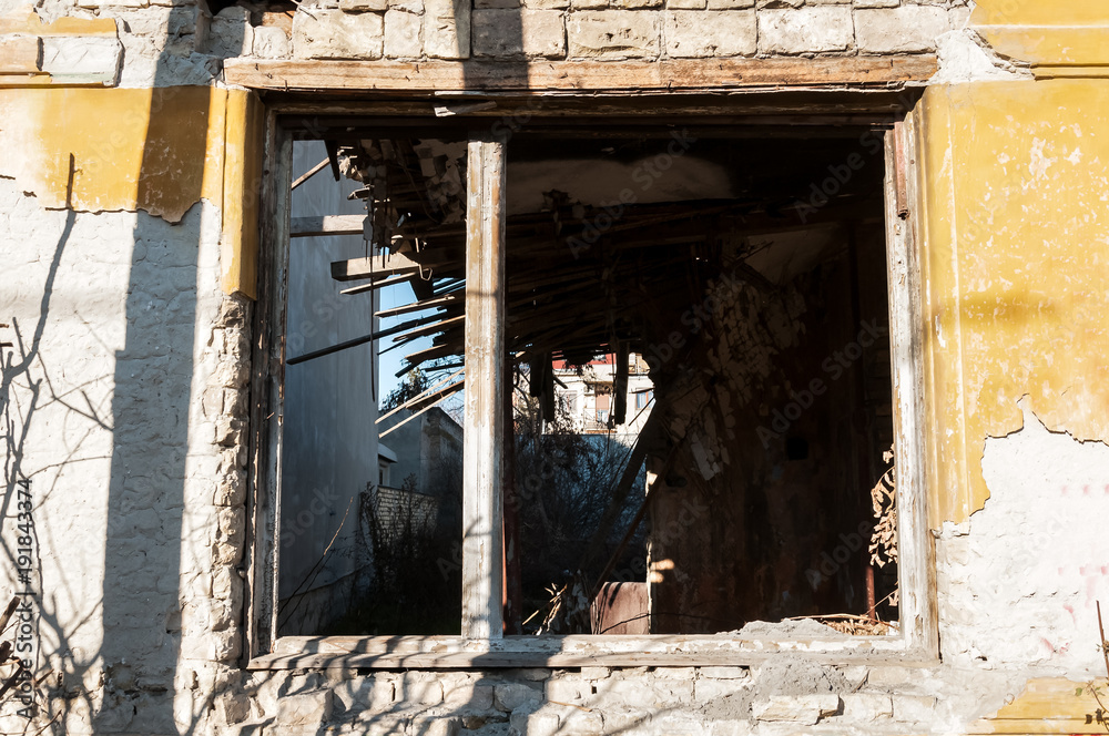 Windows and remains of abandoned damaged and destroyed house by grenade ...