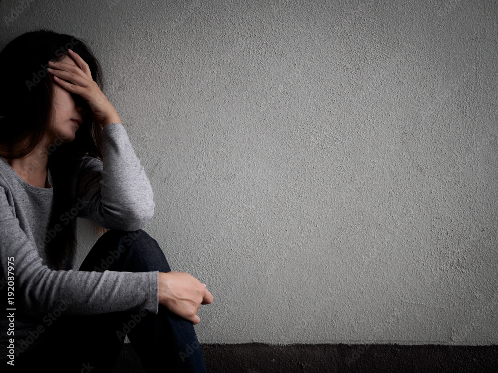 Depressed broken hearted woman sitting alone in dark room at home ...