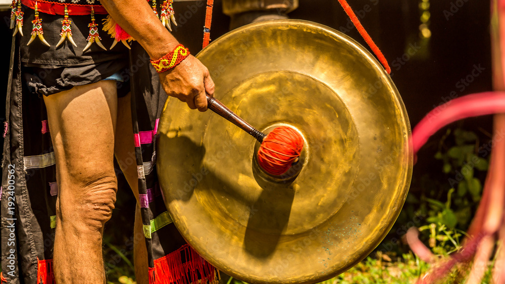 Dayak (native tribe of Borneo) man hitting the Gong on traditional ...
