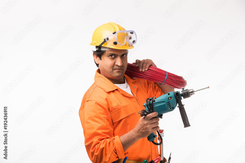 Indian electrician engineer in action with wire cutter, drilling ...