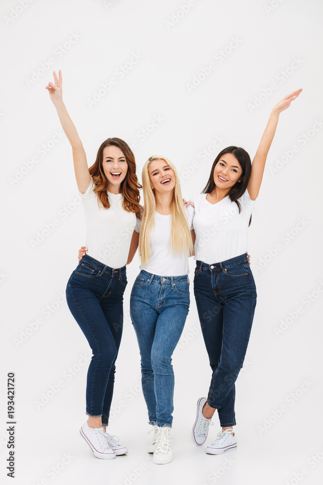 Portrait of three cheerful casual girls standing together Stock Photo ...