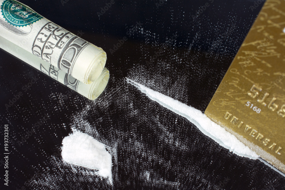 snorting and sniffing cocaine lines on mirror with rolled banknote gold ...