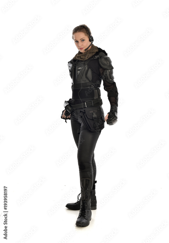 full length portrait of female soldier wearing black tactical armour ...