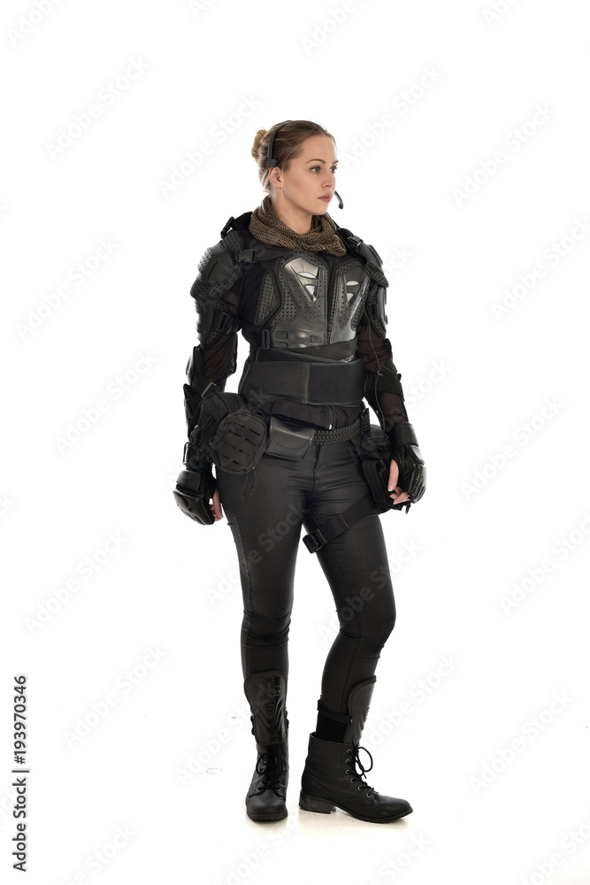 full length portrait of female soldier wearing black tactical armour ...