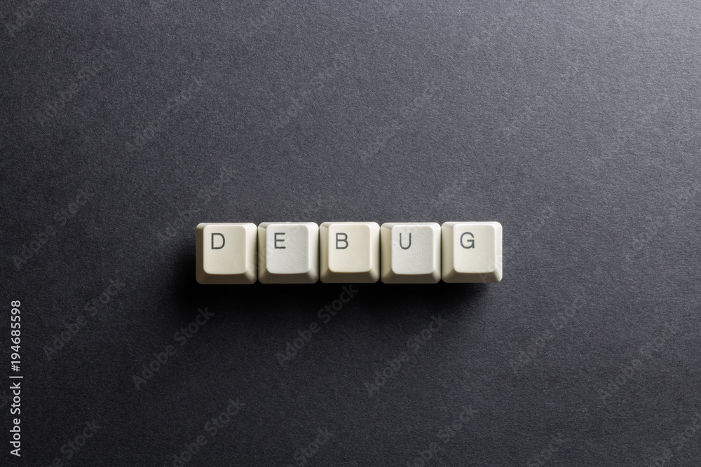 Word debug made using computer keyboard buttons on a black background. IT technology concept ...