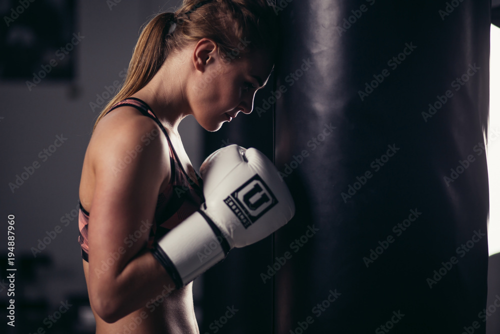sexy fighter girl in gym with boxing bag. Long hair woman fitness model ...