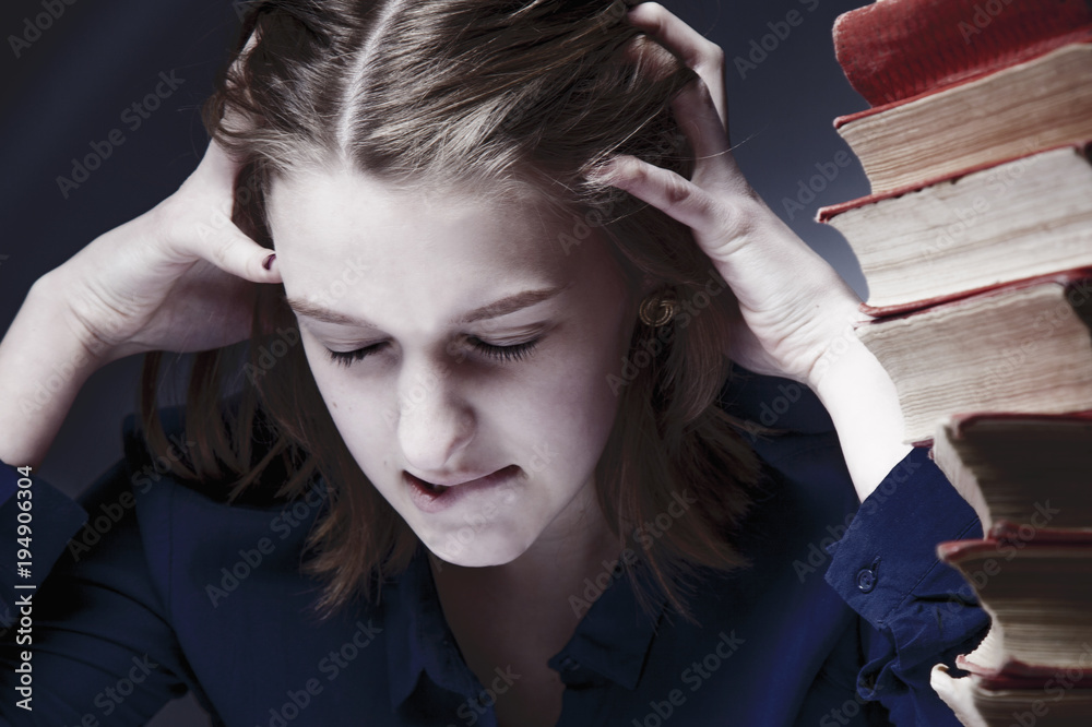 Heavy education. Young depressed female student with books feels ...