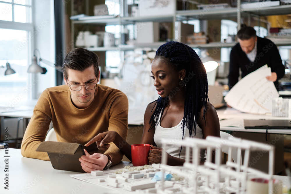 Multiracial couple working in design and engineering architecture ...