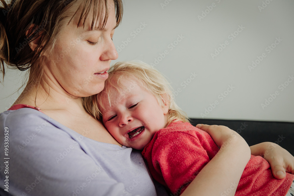 Mother comforting crying little baby Stock Photo | Adobe Stock