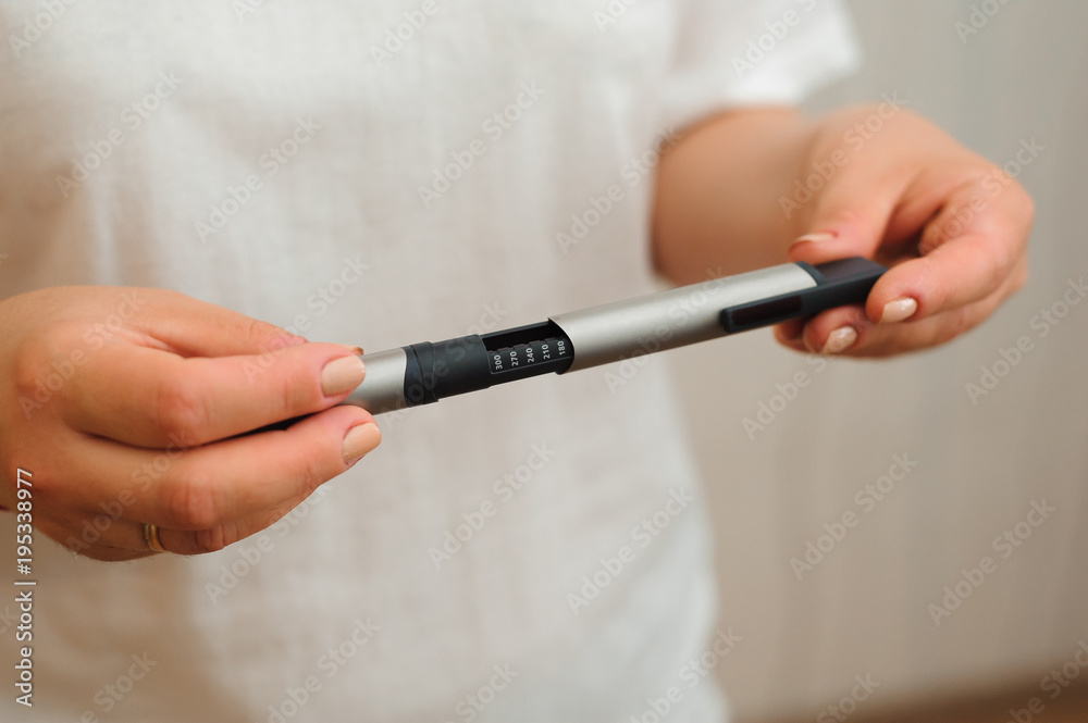 Diabetes patient turn knob on end of insulin pen and dial up correct ...