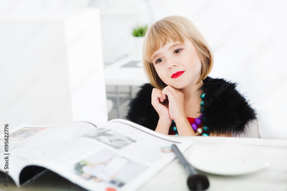 beautiful little girl in the mirror preening and using makeup . Child ...