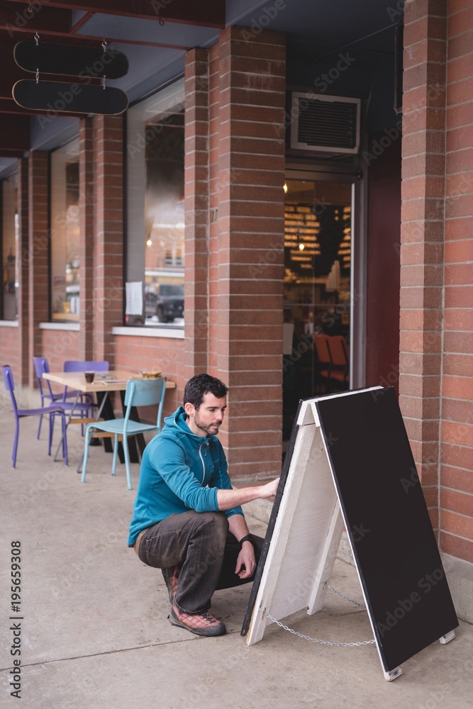 Man looking at menu board Stock Photo | Adobe Stock