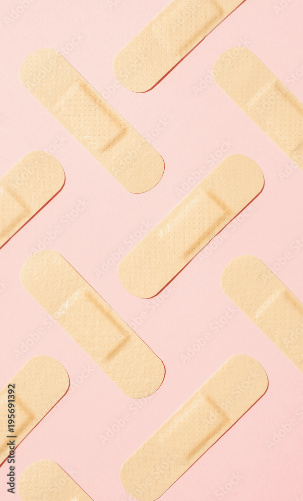 Adhesive bandages on pink background Stock Photo | Adobe Stock