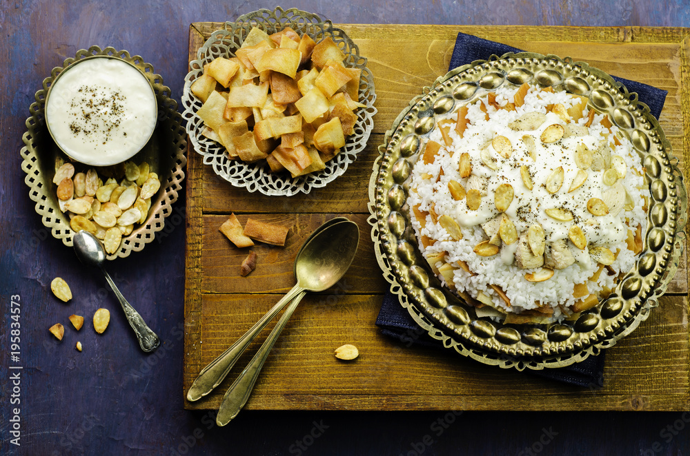 Arabic cuisine; Jordanian Chicken Mansaf of white rice and crispy fried ...