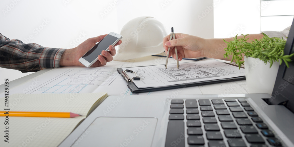 Architects working on blueprint, real estate project. Architect ...