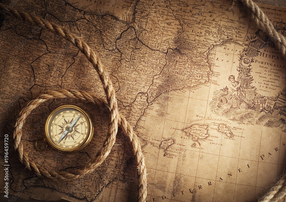 Old vintage retro compass on ancient map background. Travel geography ...