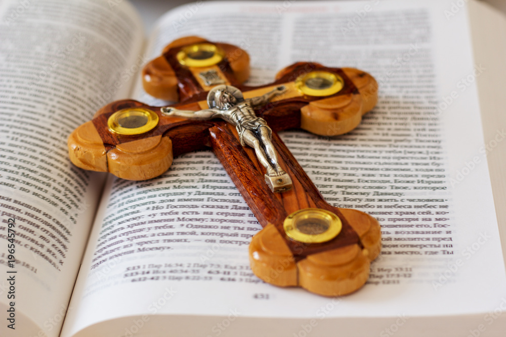 cross depicting the crucifixion of Jesus Christ on the pages of the ...