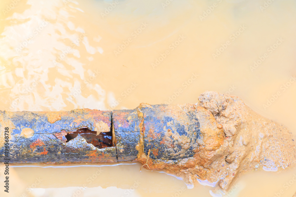 repair broken pipe in hole with plumbing water flow underground outdoor ...