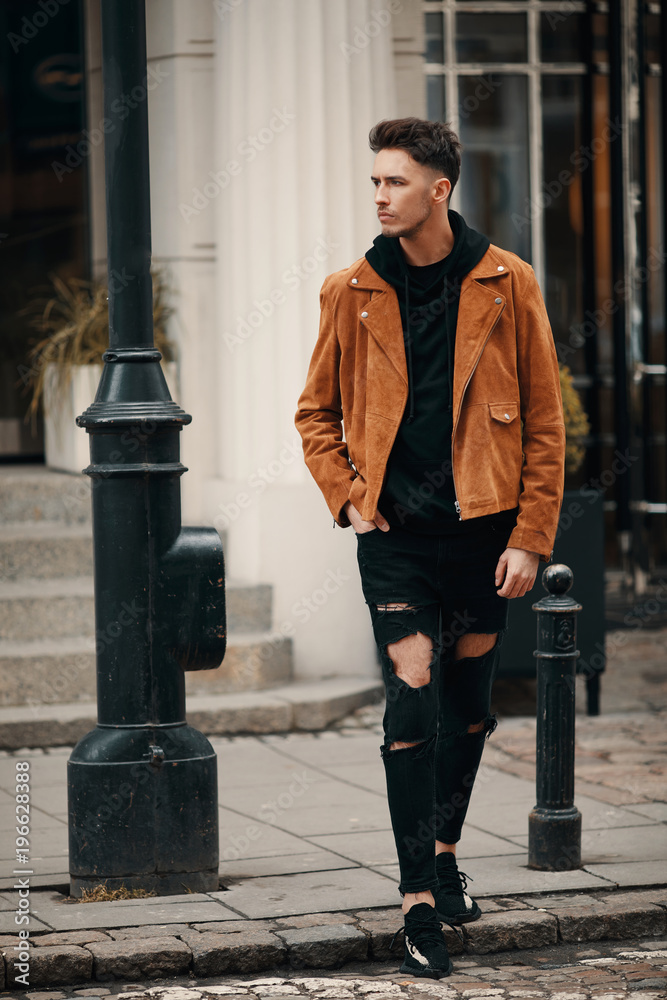 Model looking man stand on the city street with cars background, look ...
