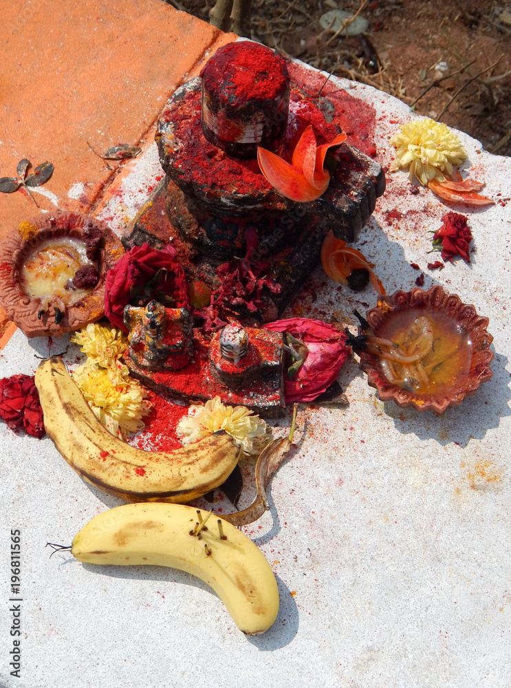 Hindu People offer prayers or do puja to stone ancient carved linga ...