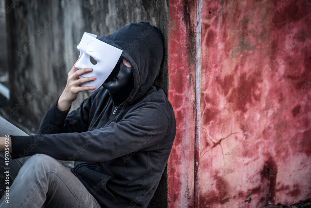 Stock-Foto „Mystery man wearing hoody jacket take of the mask showing ...