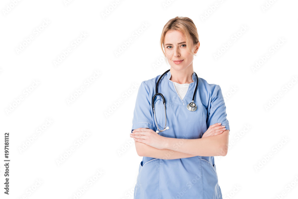 Female nurse in uniform with stethoscopes standing with arms folded ...