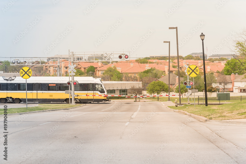 Light rail train speeding through a red alert sign level crossing in ...
