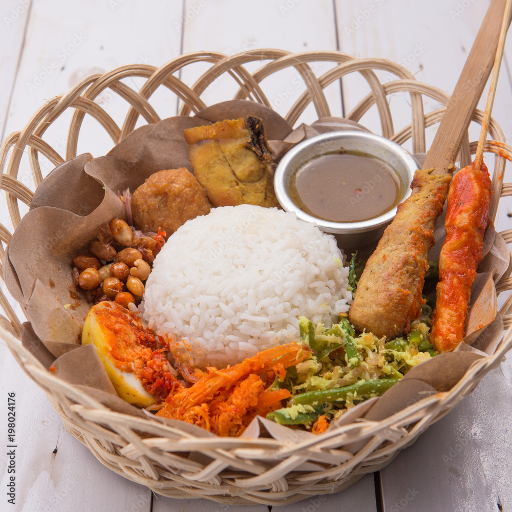 Nasi lemak / Nasi campur, Indonesian Balinese rice with potato fritter ...