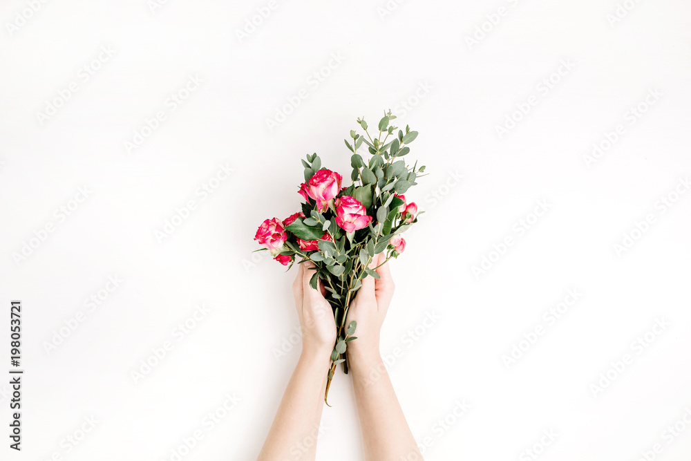 Woman hands hold rose flowers and eucalyptus branch bouquet on white ...